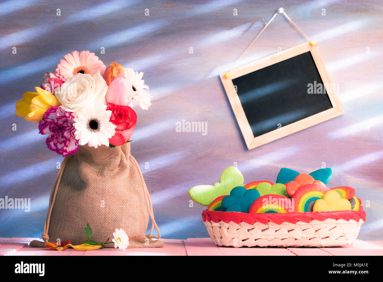 Bouquet of flowers in a jute sack, a basket full with cheerful multi ...