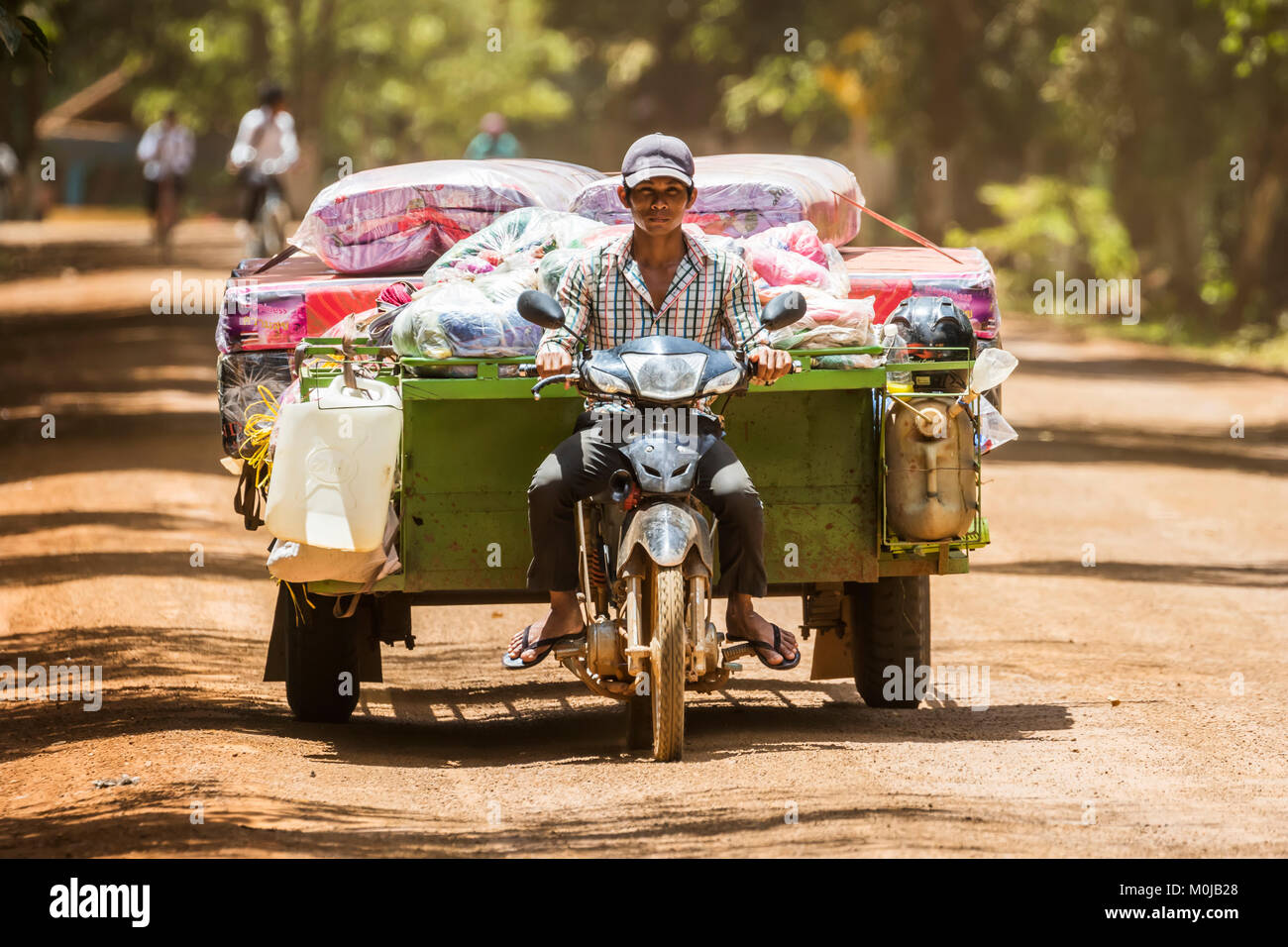 Man transporting garbage on a motorcycle; Sambor Prei Kuk, Kompong Thom ...