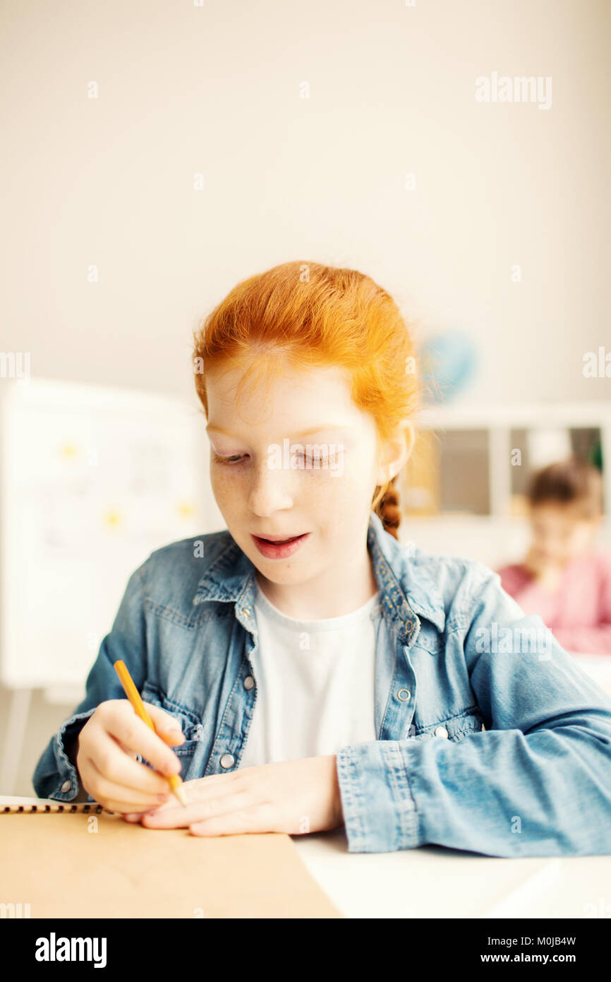 Girl drawing in notepad Stock Photo - Alamy