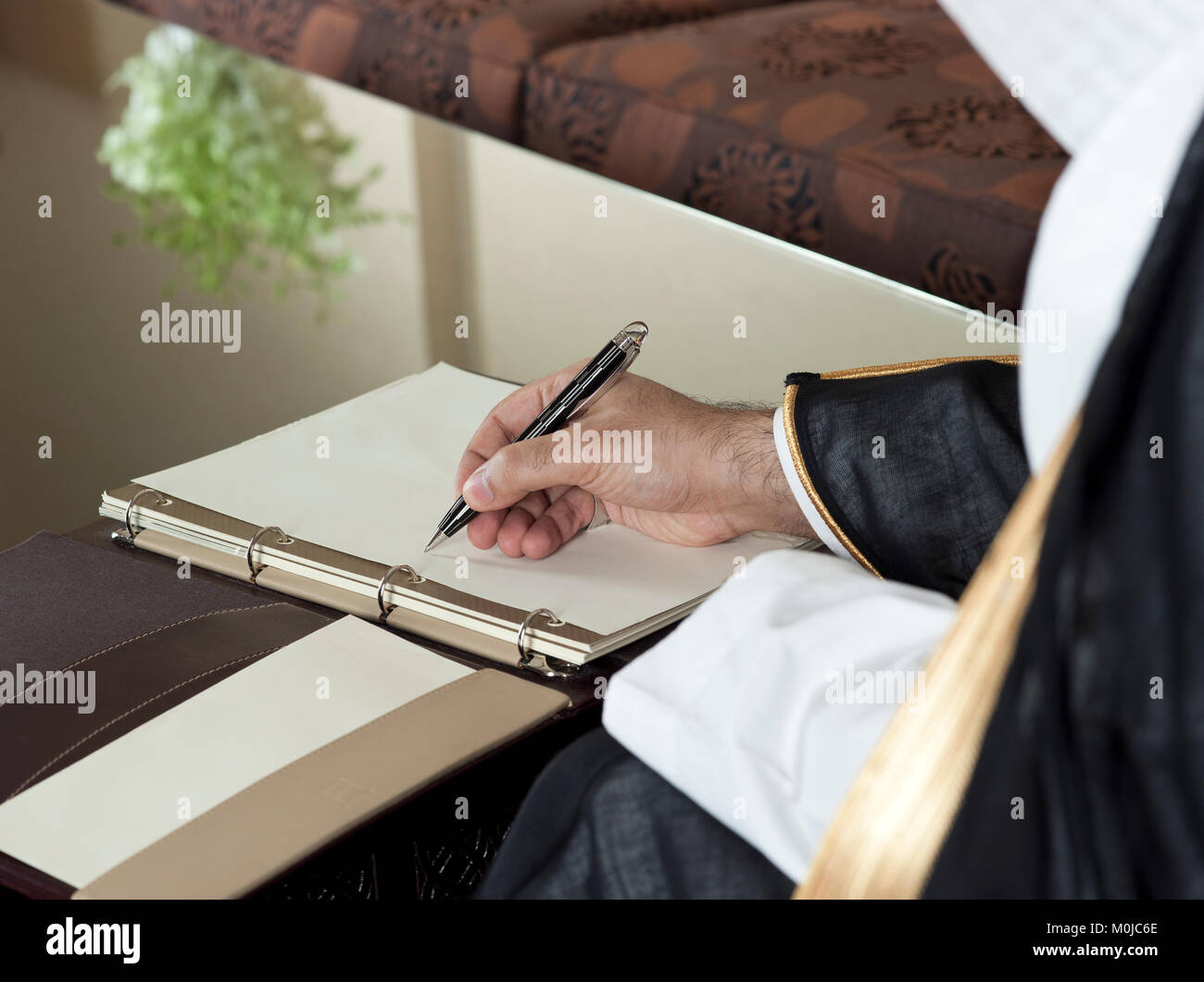 Saudi Arabian Man Hand Writing on A Notebook in a Luxury Home ...