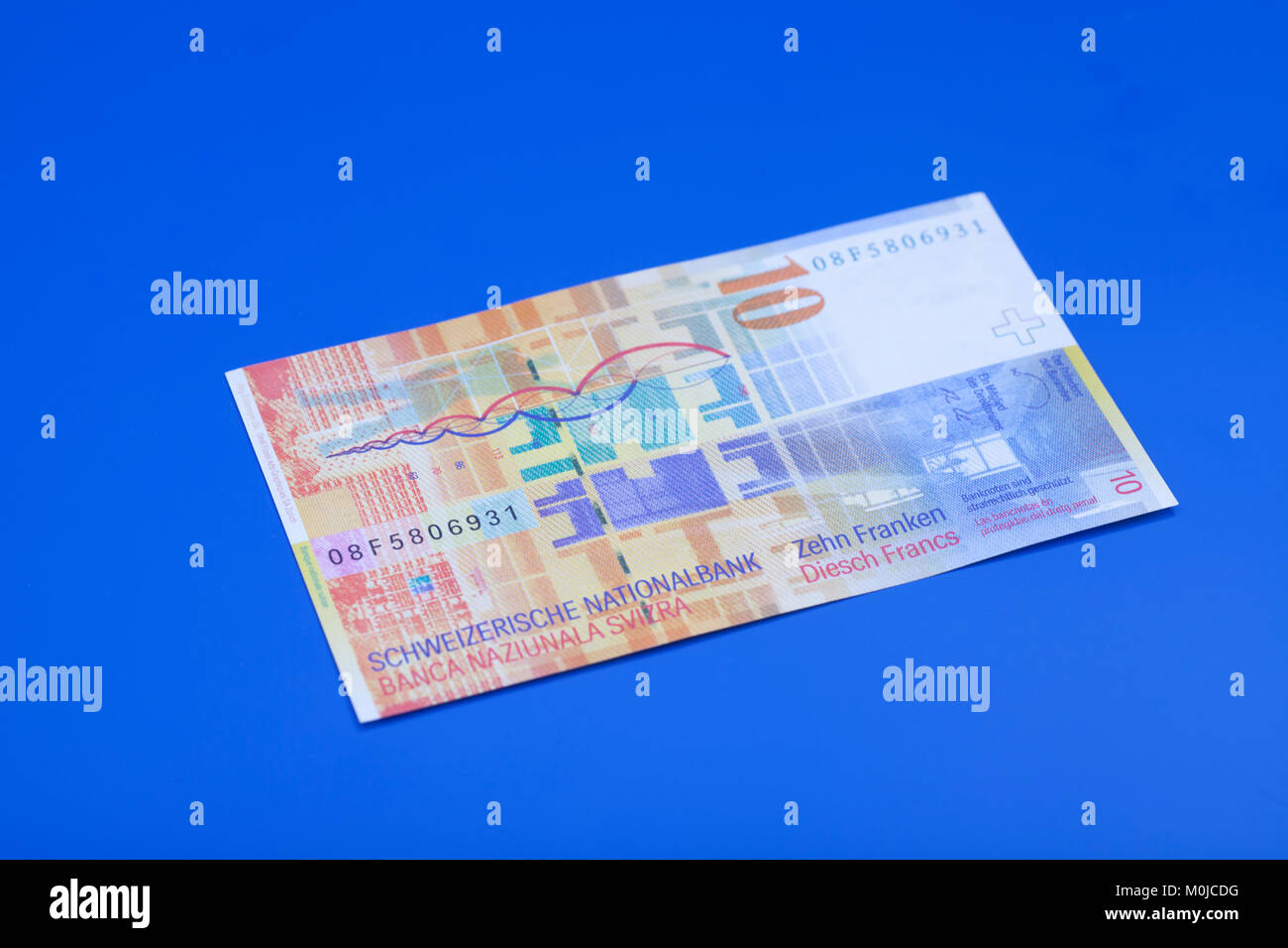 Ten Swiss Franc note on a blue background Stock Photo - Alamy