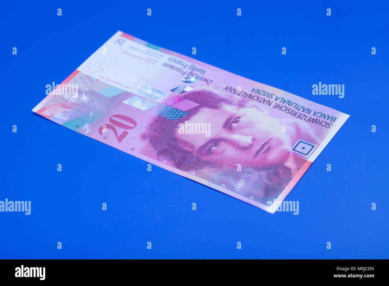 Twenty Swiss Franc note on blue background Stock Photo - Alamy