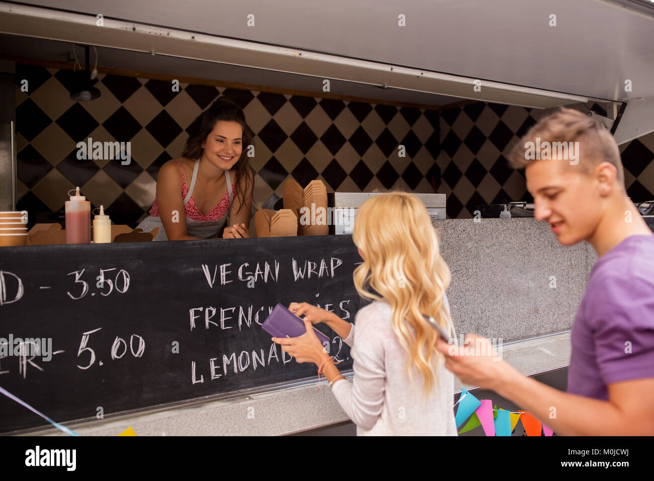 happy customers queue at food truck Stock Photo - Alamy