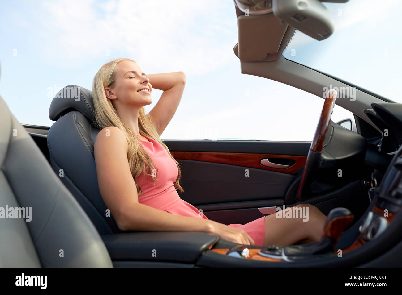 happy young woman in convertible car Stock Photo - Alamy