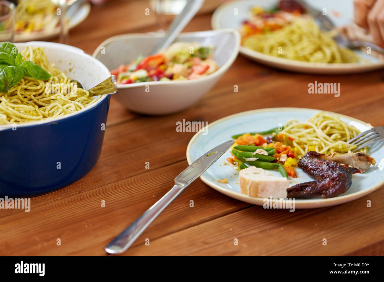 plate with food on wooden table Stock Photo - Alamy