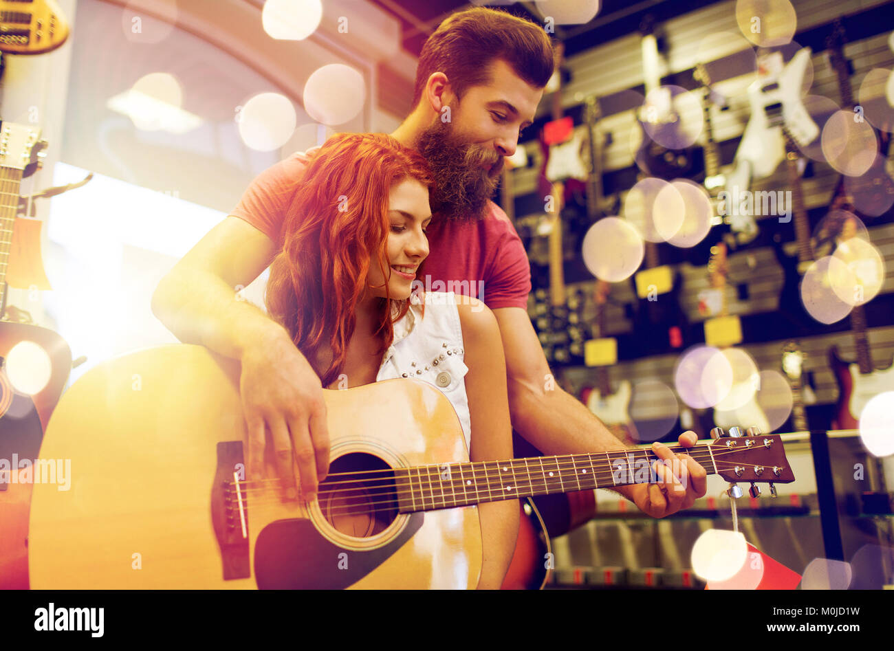 couple of musicians with guitar at music store Stock Photo - Alamy