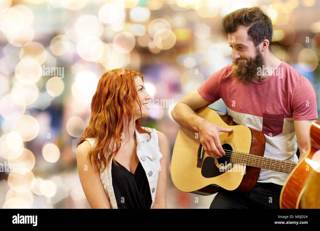 couple of musicians playing guitar over lights Stock Photo - Alamy