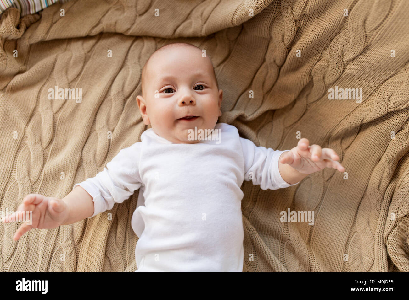 sweet little baby boy lying on knitted blanket Stock Photo - Alamy