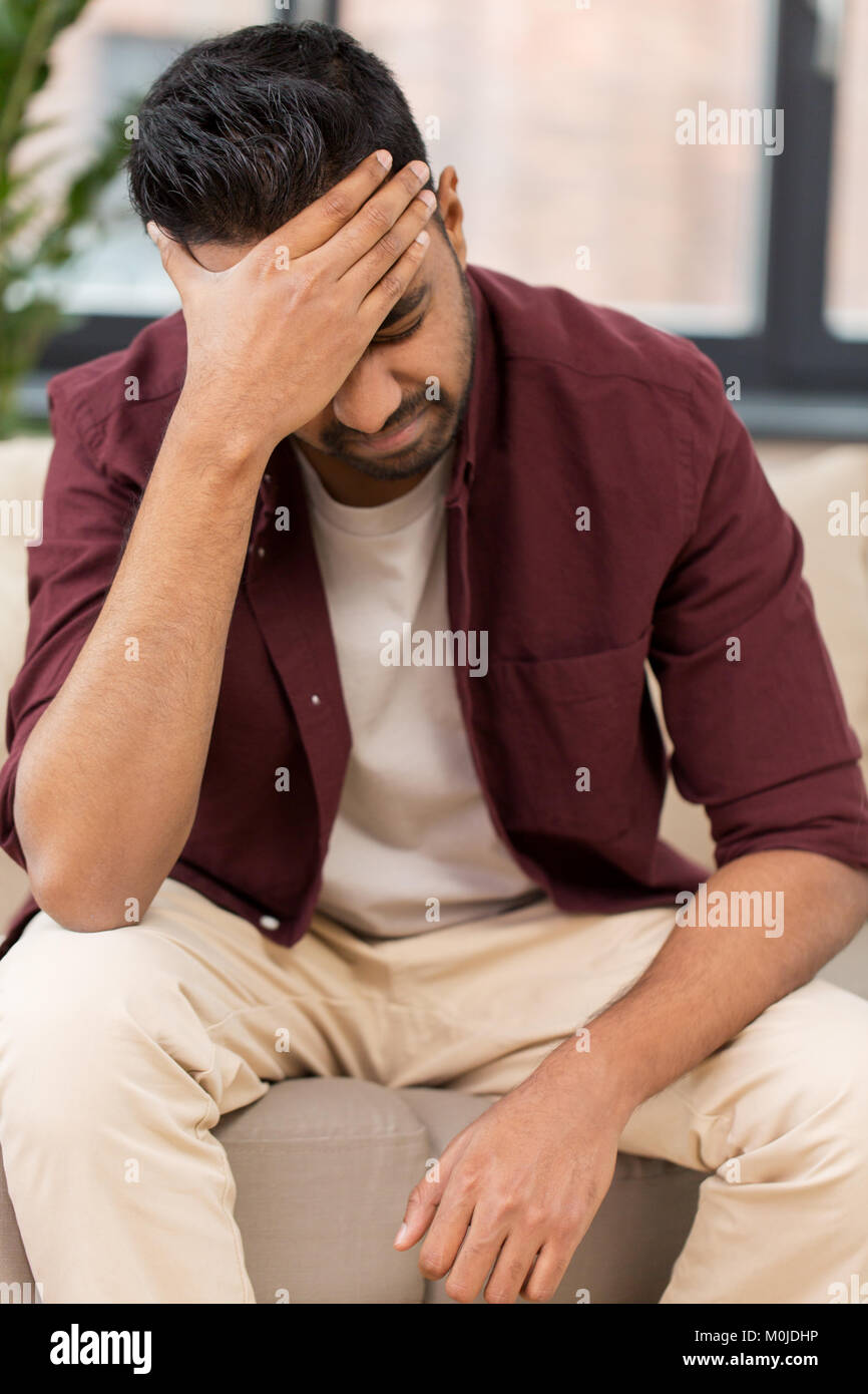 unhappy man suffering from head ache at home Stock Photo - Alamy