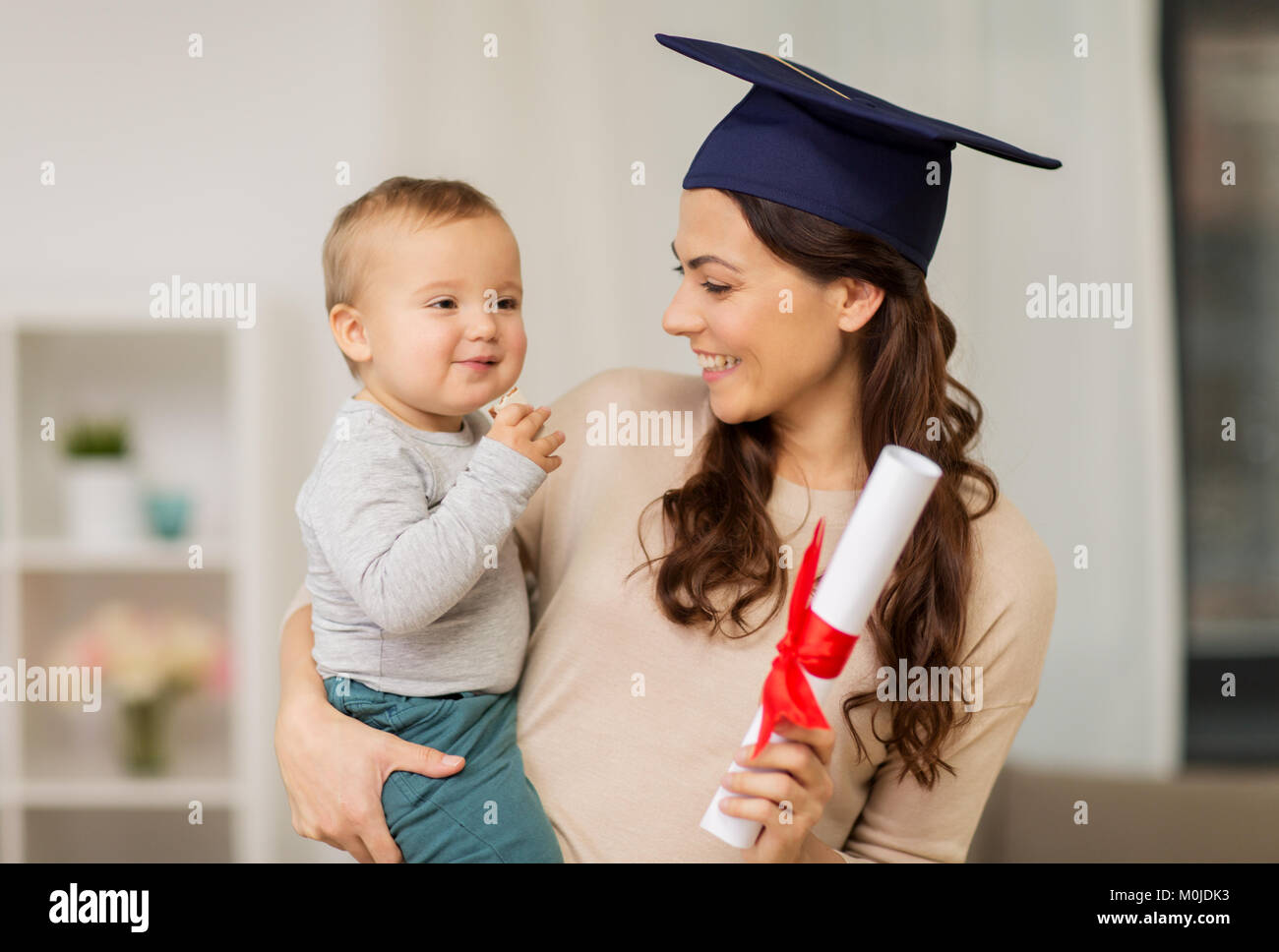mother student with baby boy and diploma at home Stock Photo - Alamy