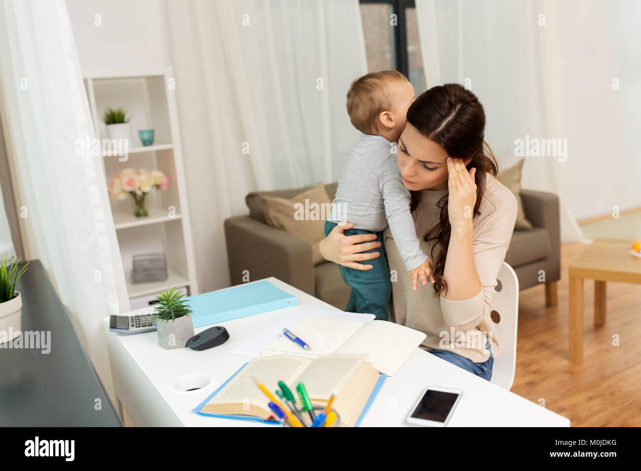 mother student with baby learning at home Stock Photo - Alamy