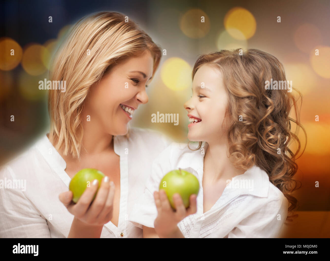 happy mother and daughter with green apples Stock Photo - Alamy