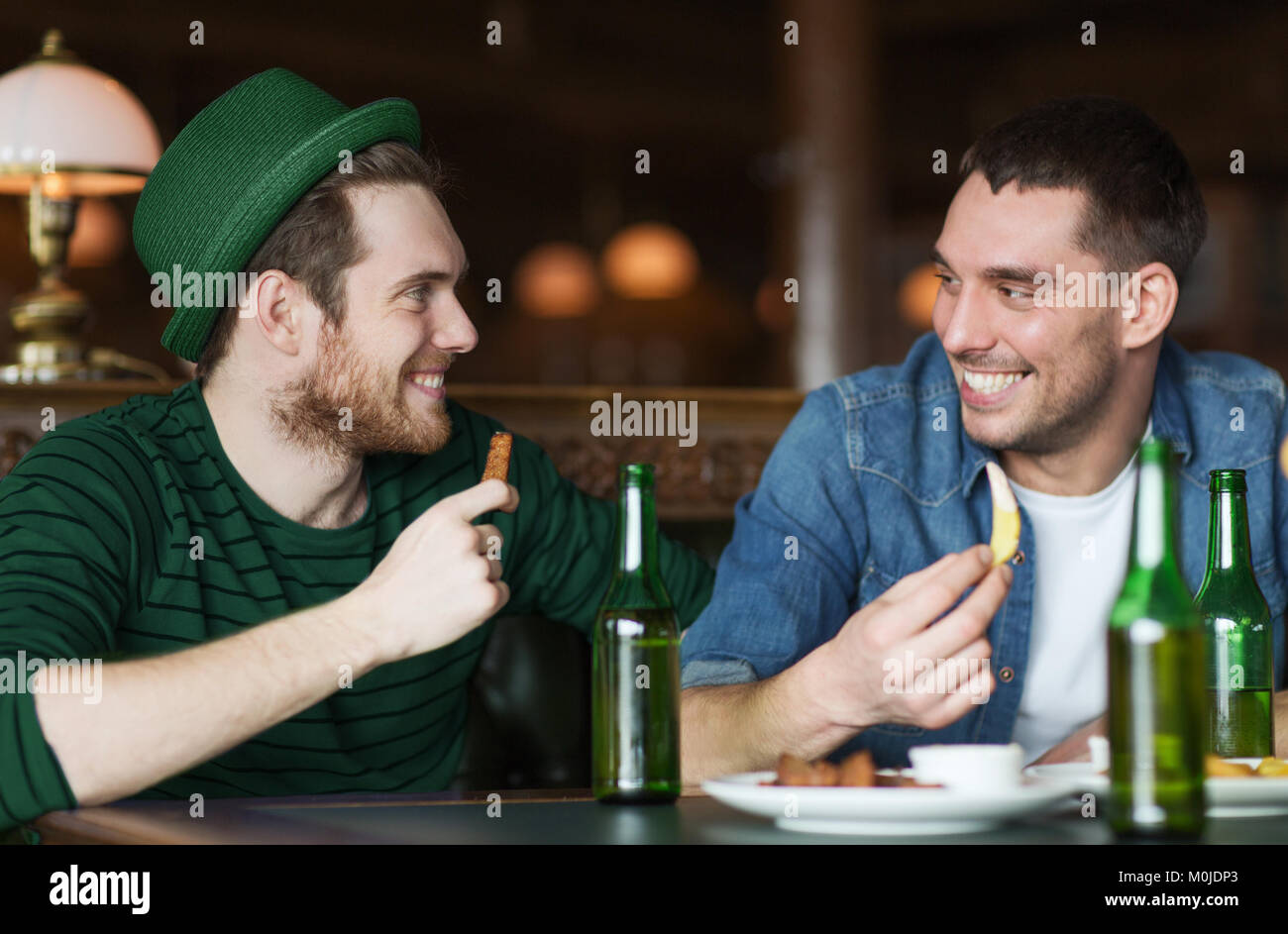 happy male friends drinking beer at bar or pub Stock Photo - Alamy