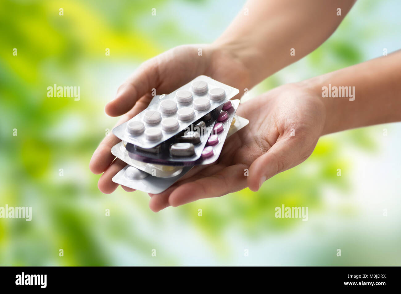 woman hands holding packs of pills Stock Photo - Alamy
