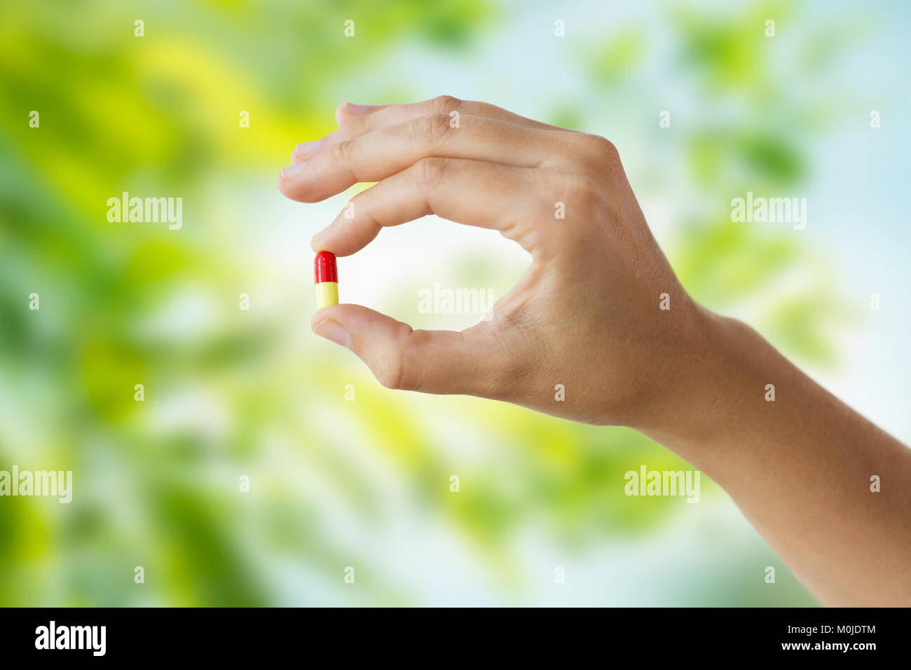 close up of hand holding capsule of medicine Stock Photo - Alamy