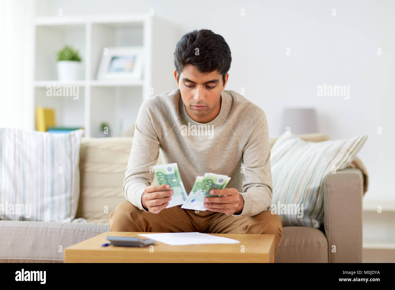 man counting money at home Stock Photo - Alamy