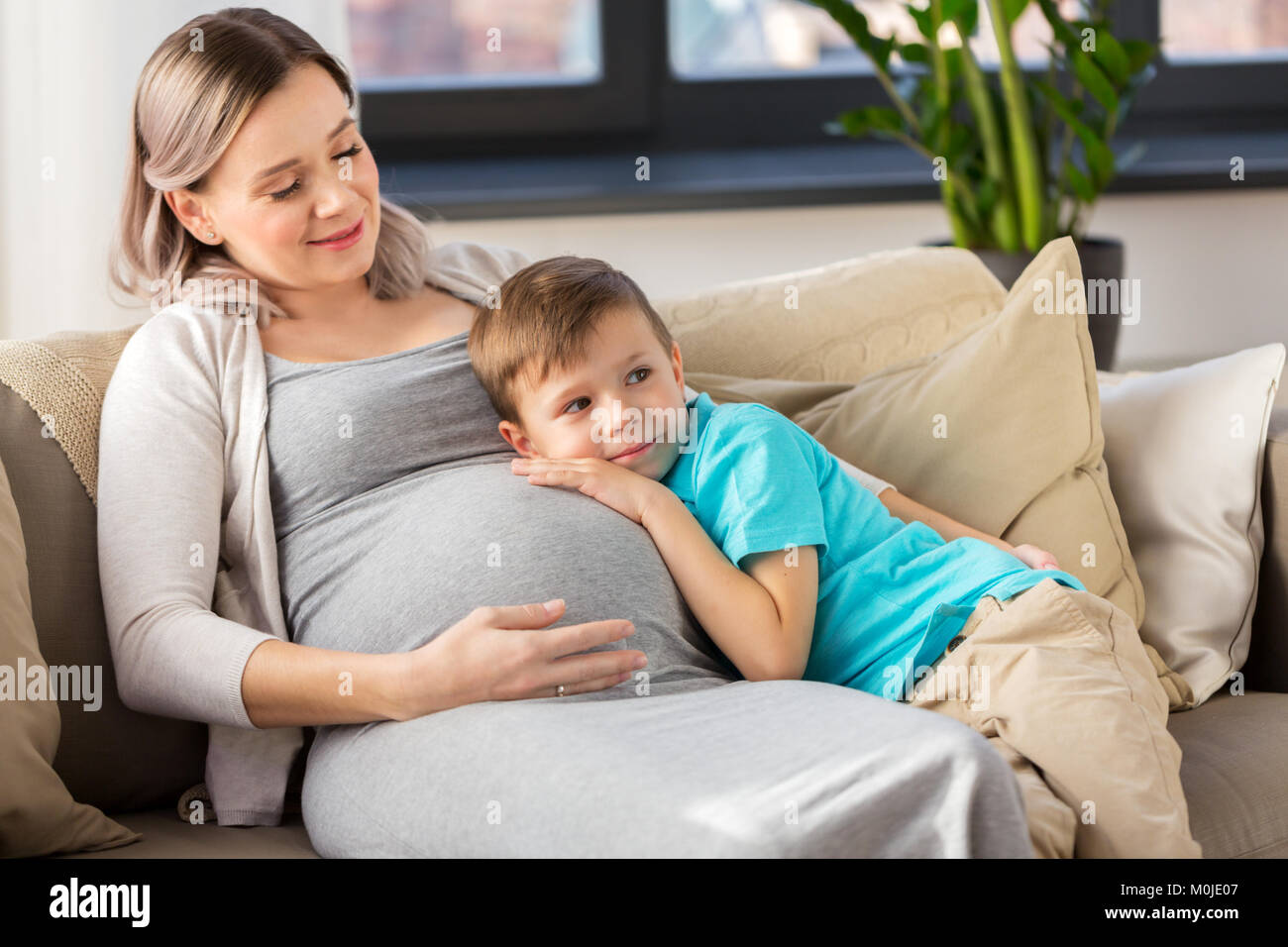 happy pregnant mother and son hugging at home Stock Photo - Alamy