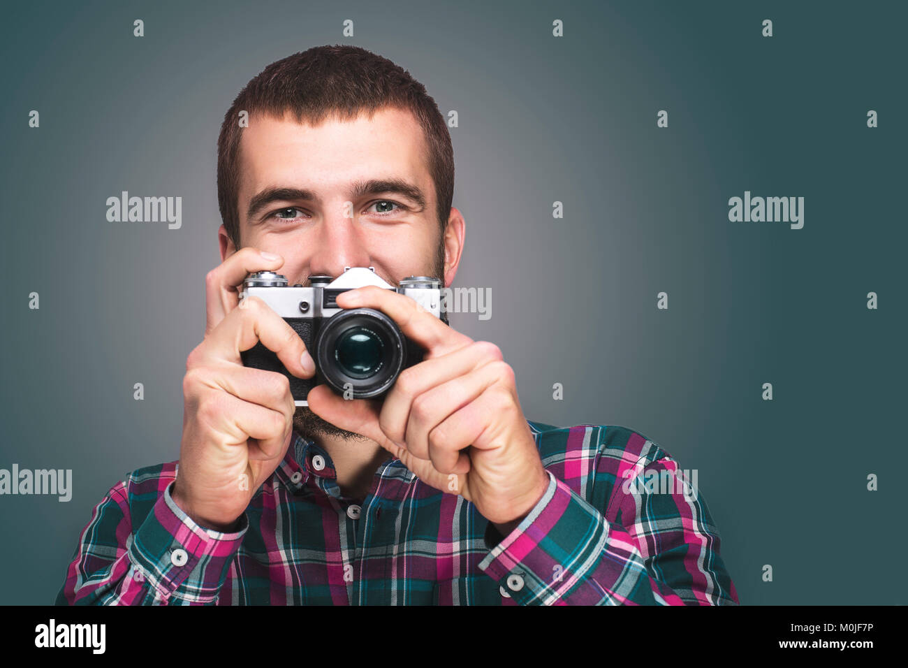 Hipster fashion photographer man holding retro camera Toned Stock Photo ...