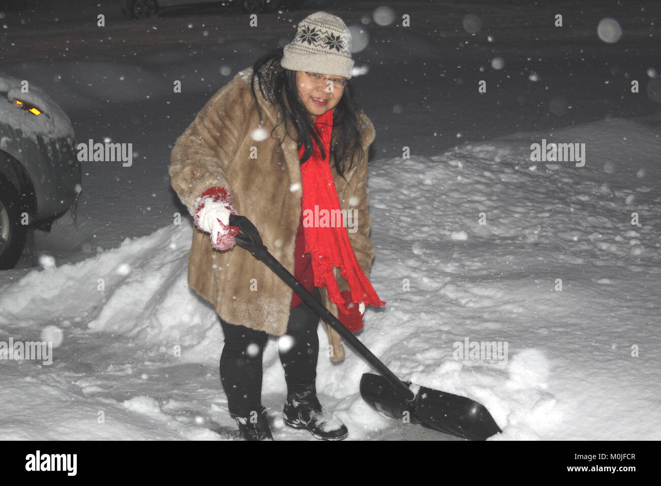 Lady with shovel, clearing deep snow, covering a sidewalk Stock Photo ...