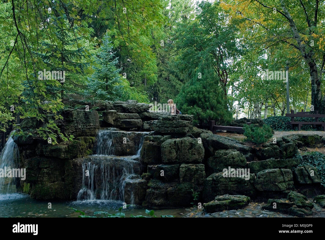 A beautiful setting of a young girl looking over a waterfall Stock ...