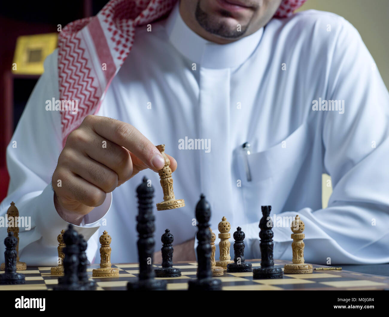 An Arab man playing chess at his desk Stock Photo - Alamy