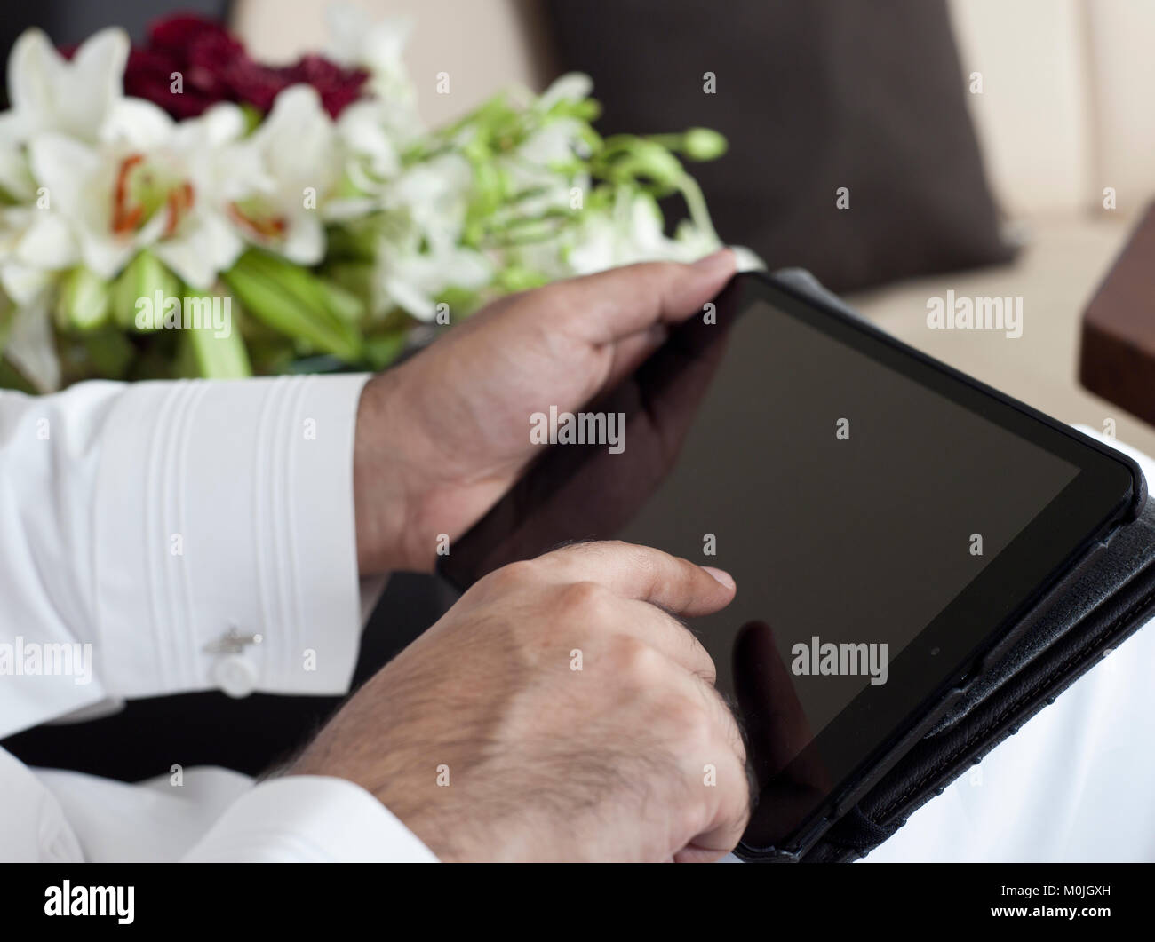Saudi Arabian VIP Hands Holding and Using Tablet Stock Photo - Alamy