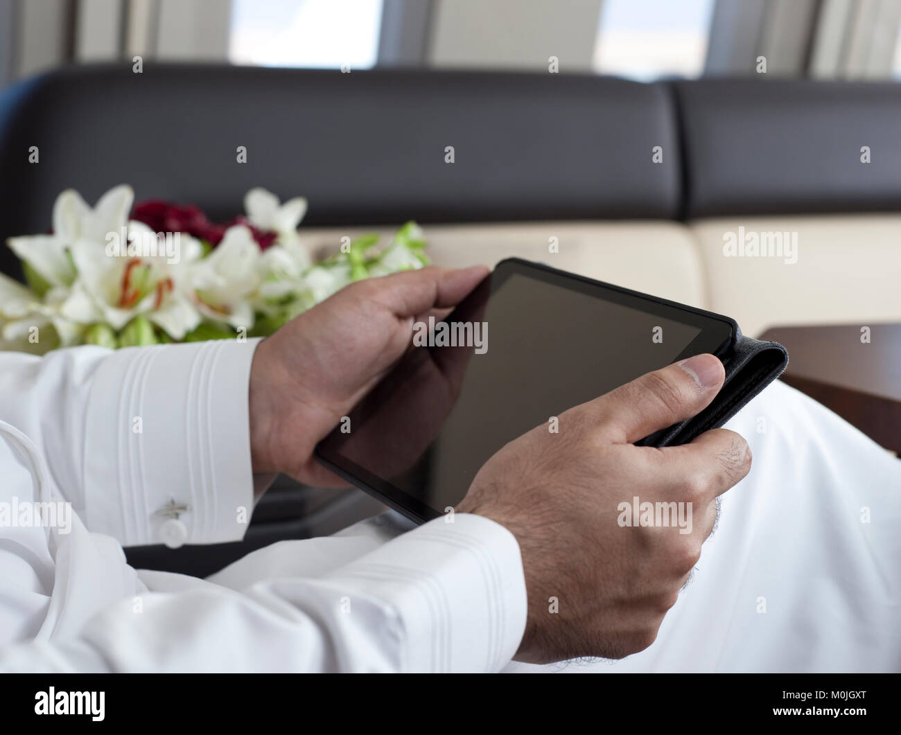 Saudi Arabian VIP Hands Holding and Using Tablet Stock Photo - Alamy