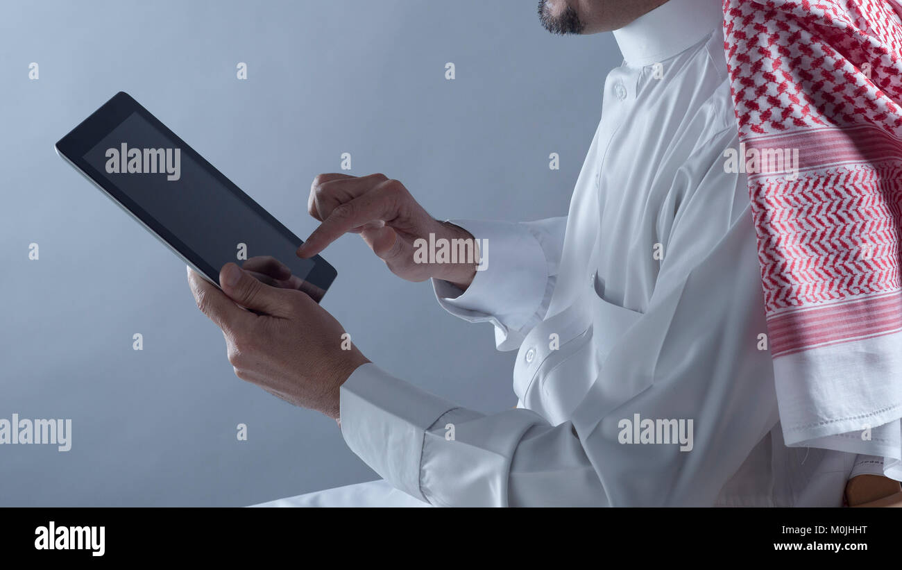 Saudi Arabian Man Hands Holding and Using Tablet Stock Photo - Alamy