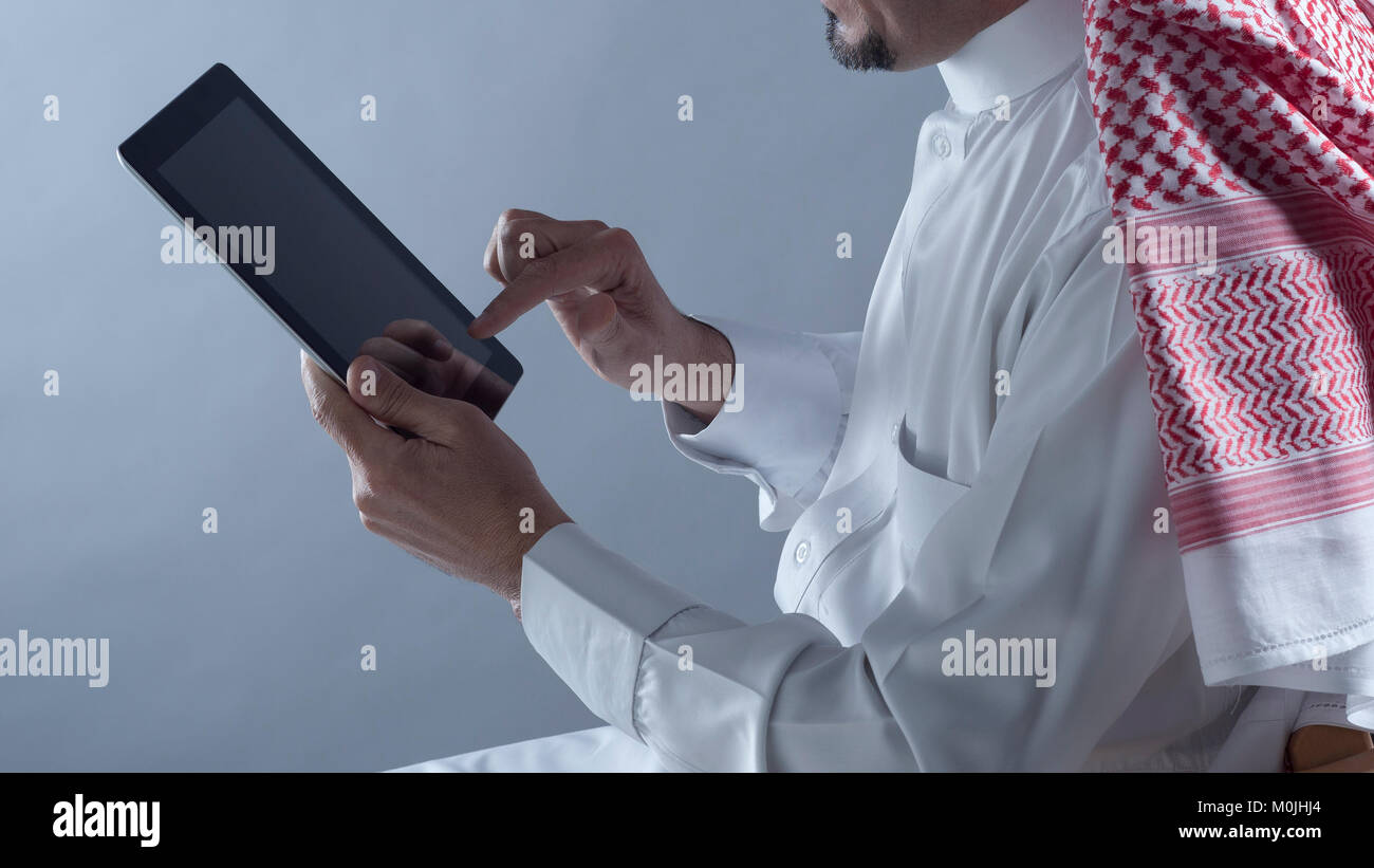 Saudi Arabian Man Hands Holding and Using Tablet Stock Photo - Alamy