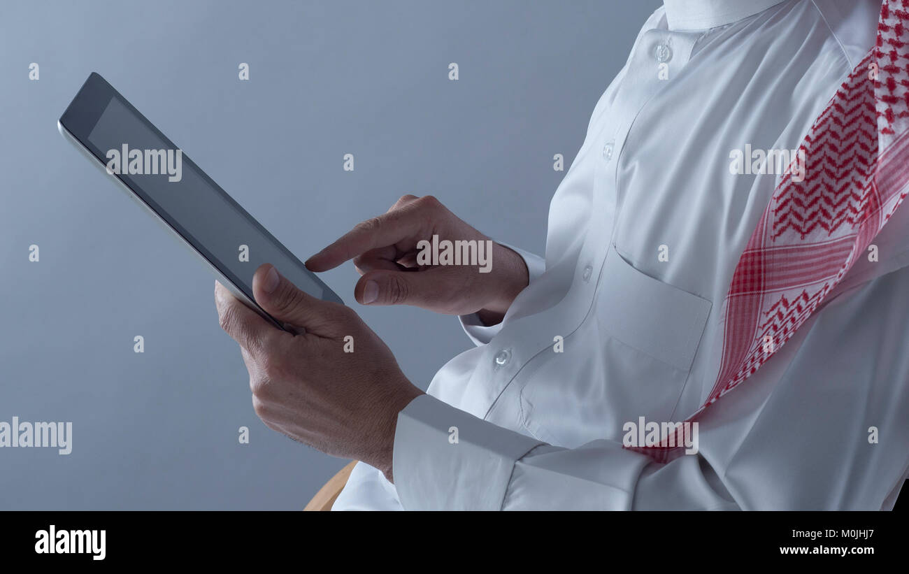 Saudi Arabian Man Hands Holding and Using Tablet Stock Photo - Alamy