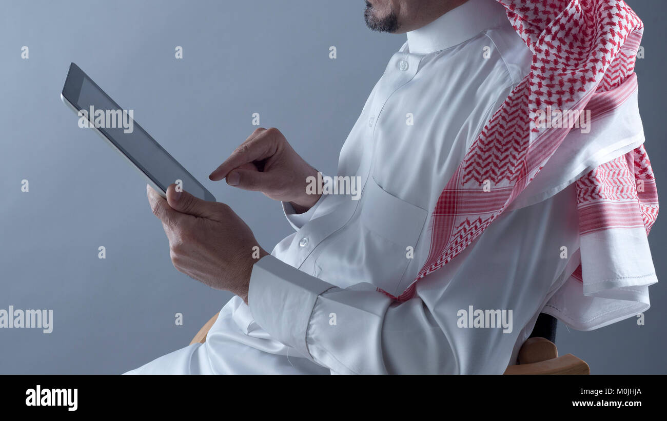 Saudi Arabian Man Hands Holding and Using Tablet Stock Photo - Alamy