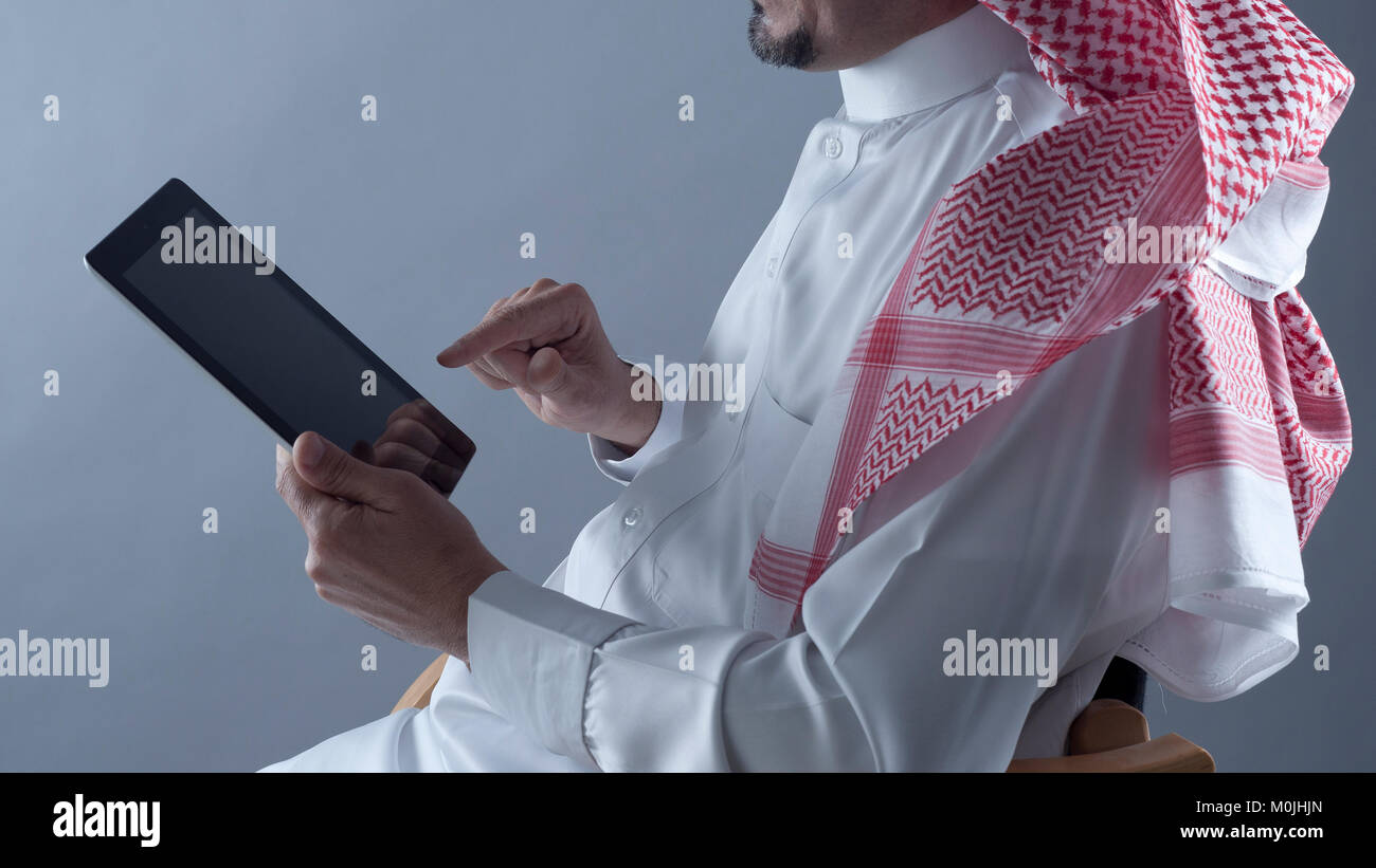 Saudi Arabian Man Hands Holding and Using Tablet Stock Photo - Alamy