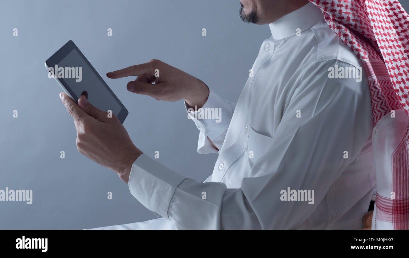 Saudi Arabian Man Hands Holding and Using Tablet Stock Photo - Alamy