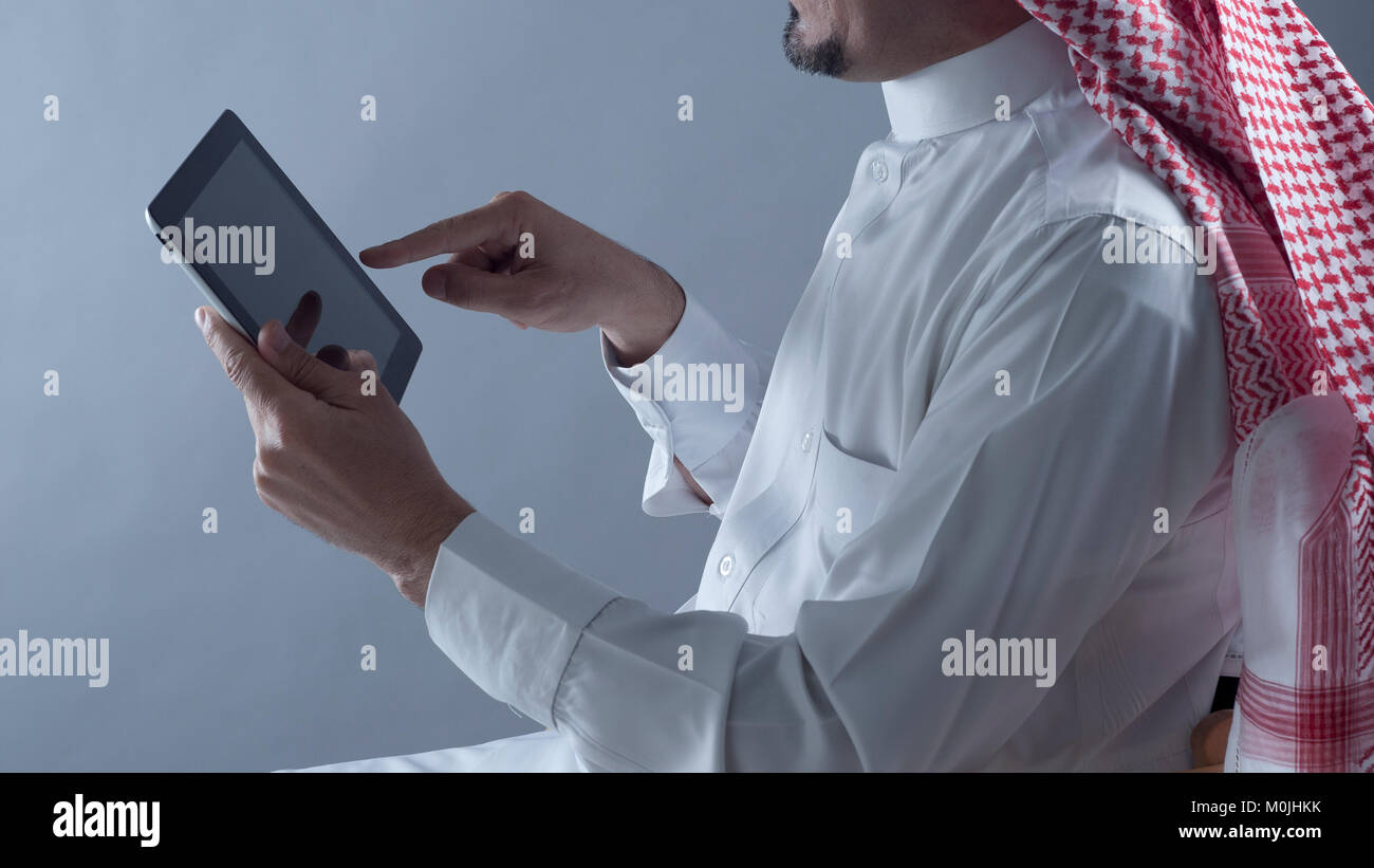 Saudi Arabian Man Hands Holding and Using Tablet Stock Photo - Alamy