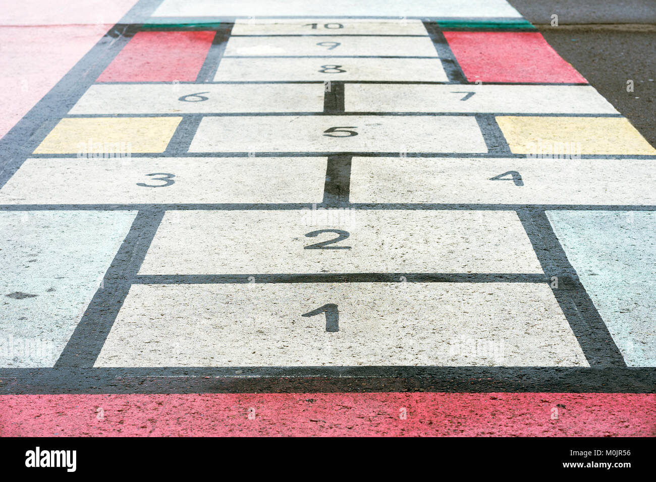 Classiic children game, hopscotch board drawn on asphalt, texture ...