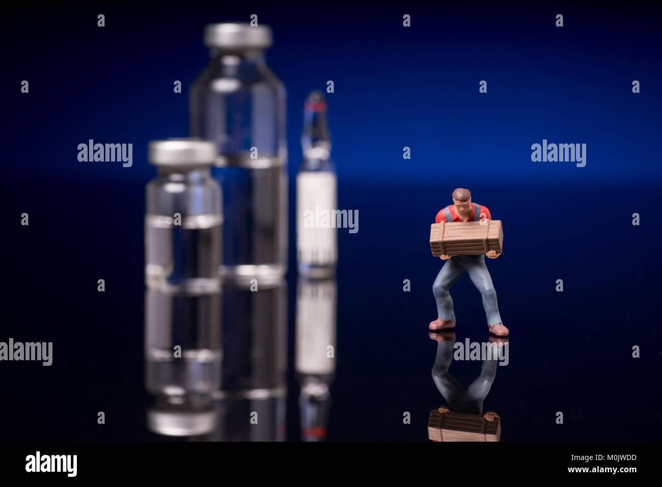 Medical vials with clear liquid and work men Stock Photo - Alamy