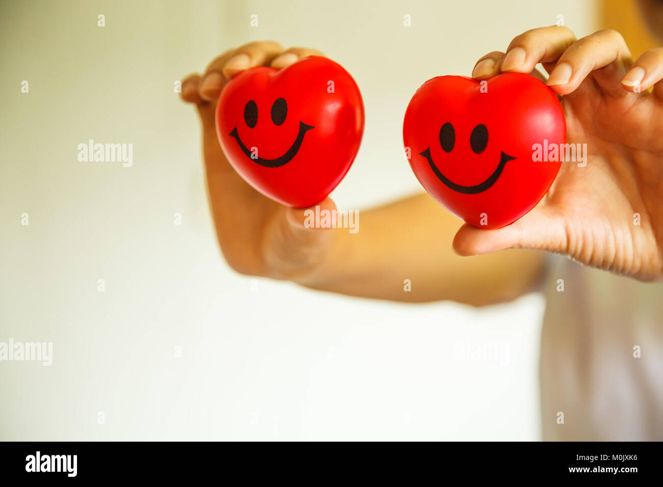 Two Red Smiling Hearts held by female nurse's hands, representing ...
