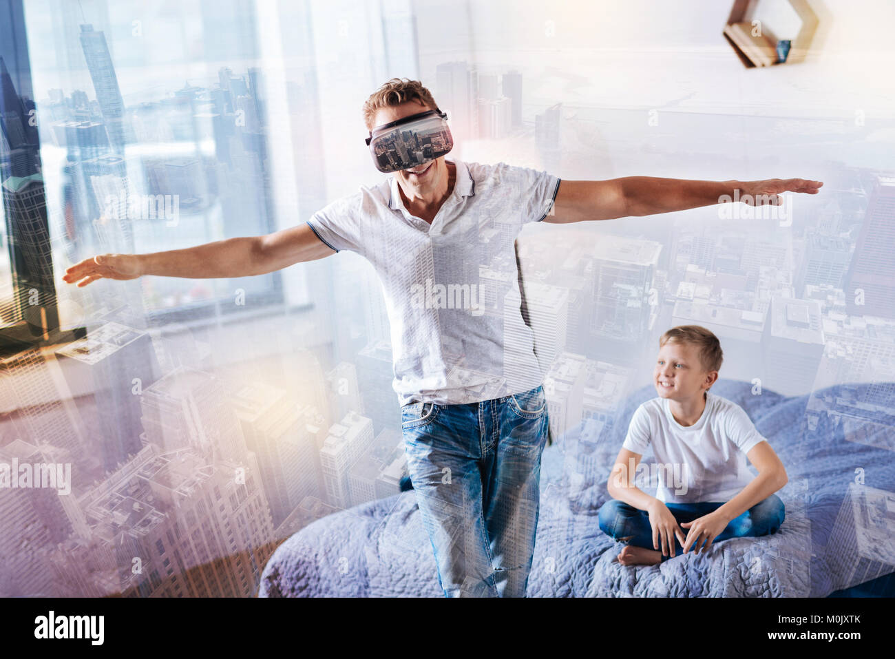 Relaxed boy sitting with crossed legs Stock Photo - Alamy