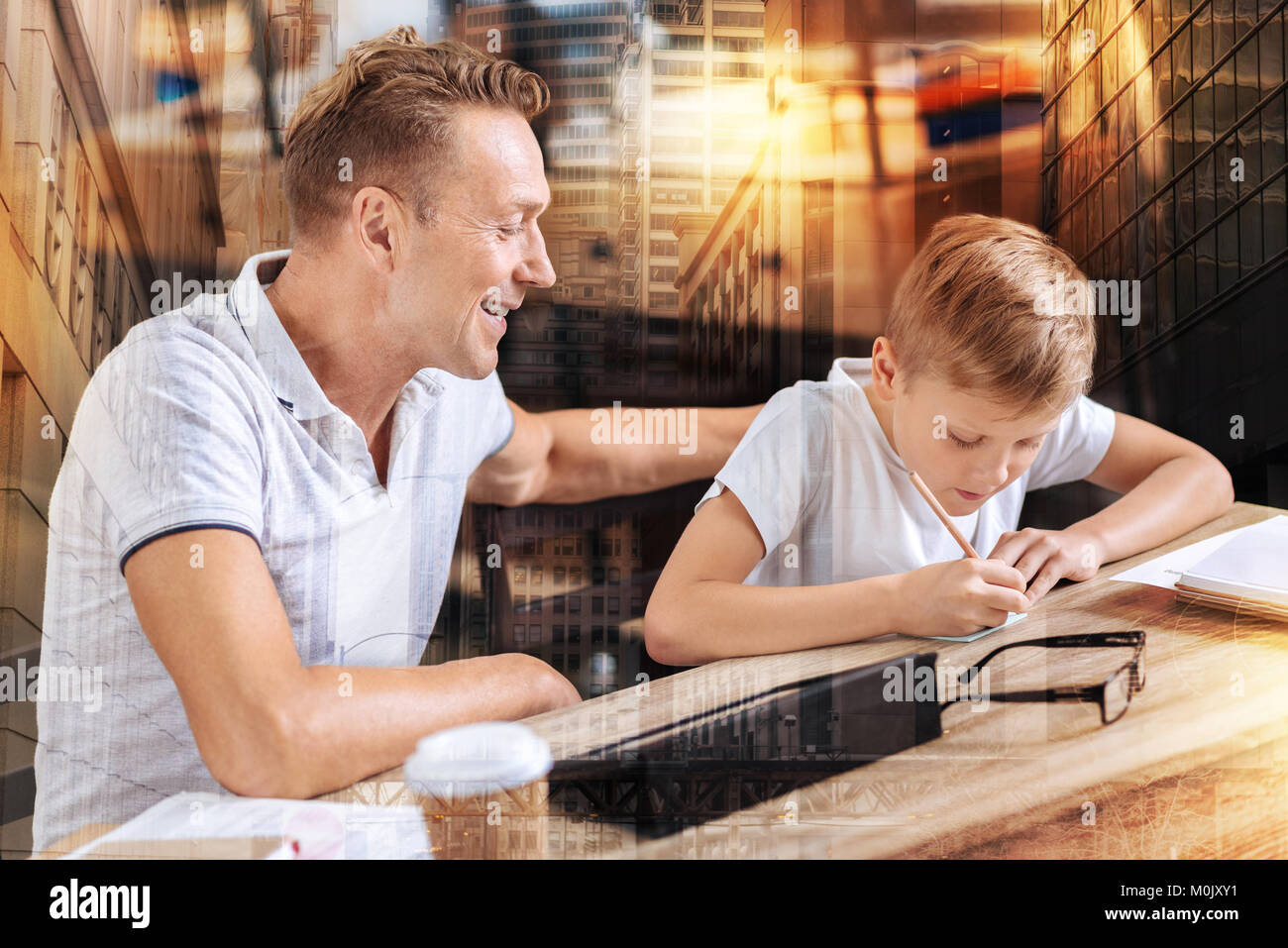 Attentive boy doing his home task Stock Photo - Alamy
