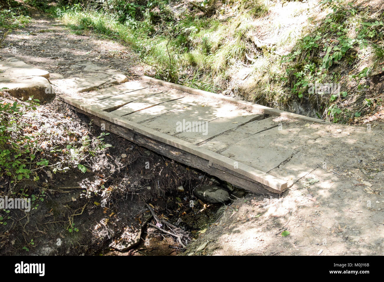 Wooden bridge over a ravine. A small bridge Stock Photo - Alamy
