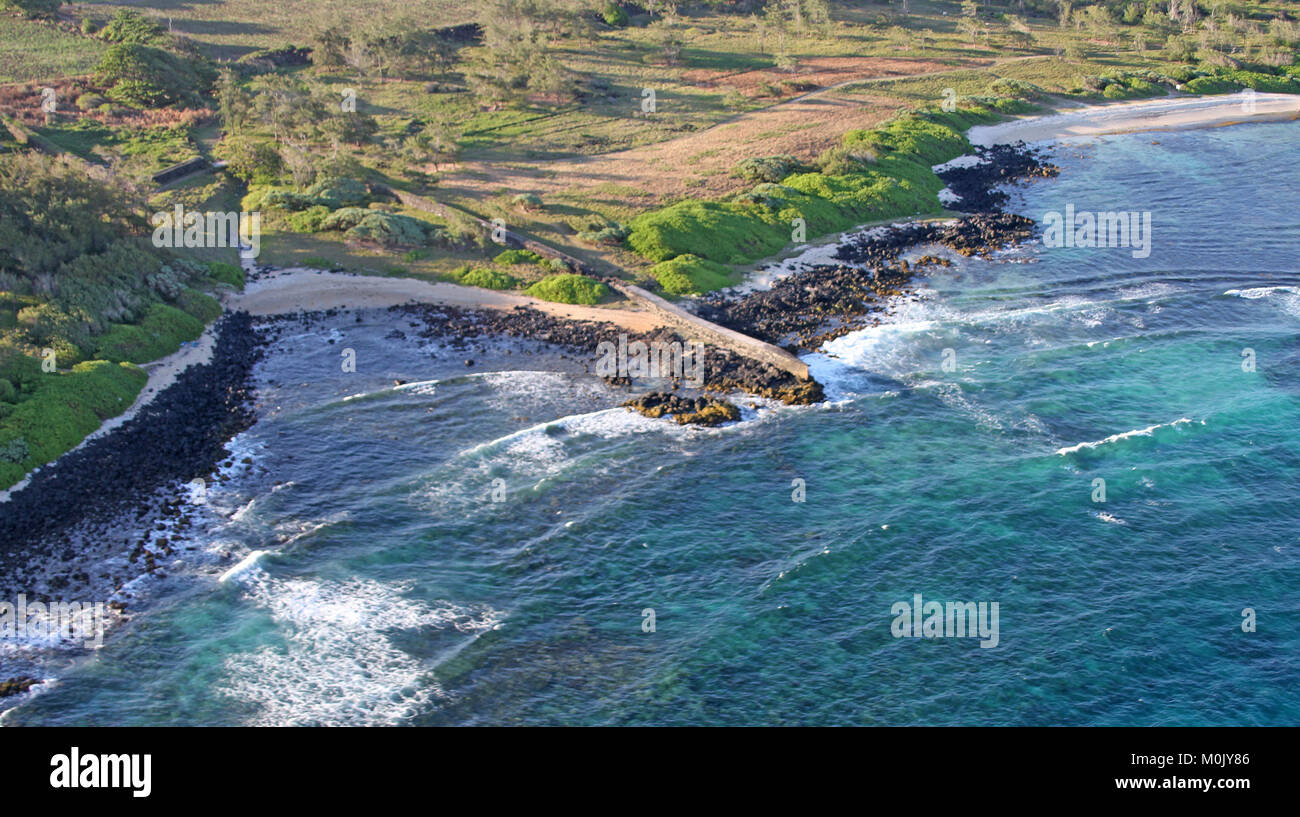 Narrow sidewalk becoming pier from field to rocky beach, view from ...