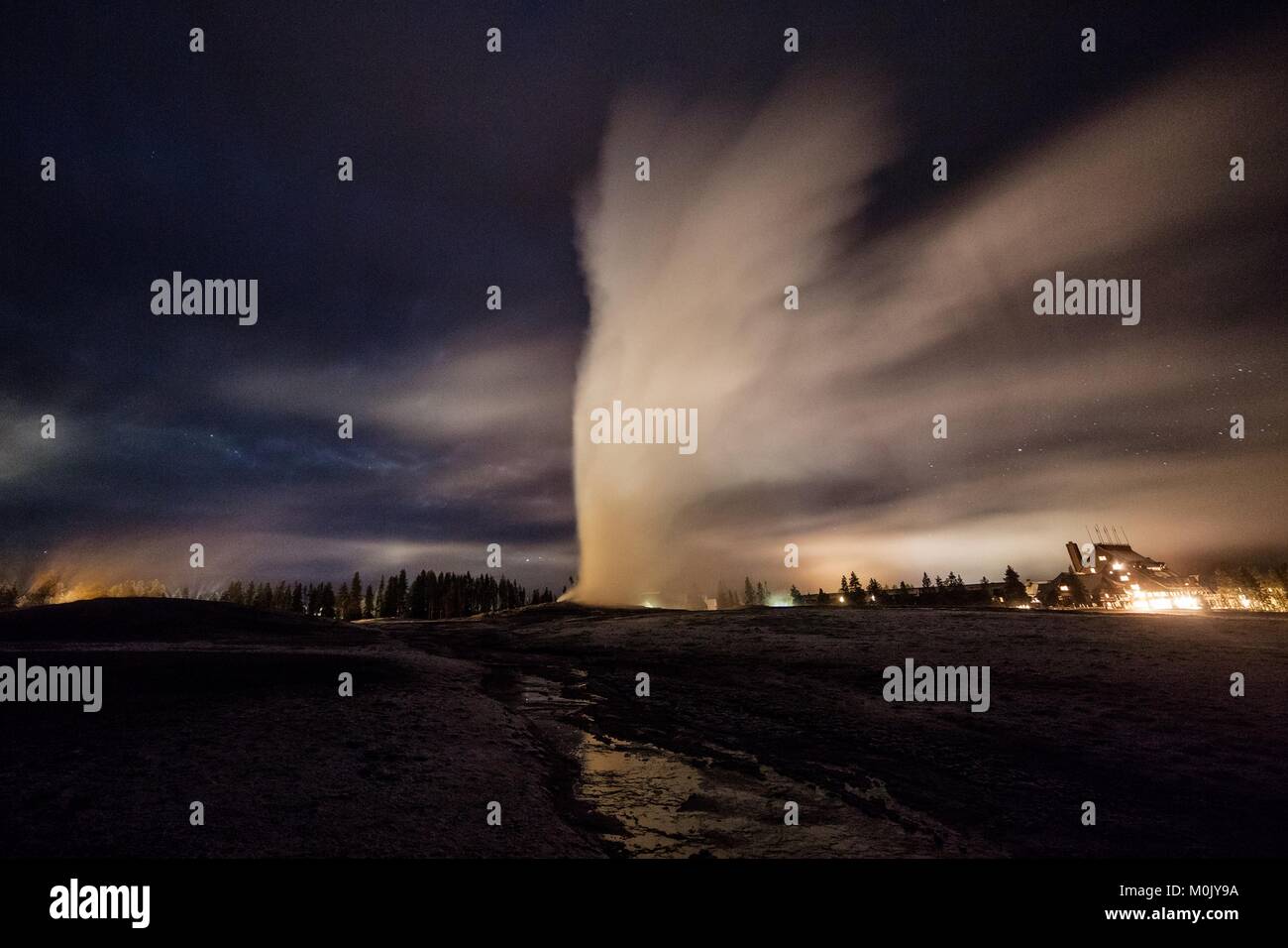 The Old Faithful Geyser erupts under the night sky in the Upper Geyser ...