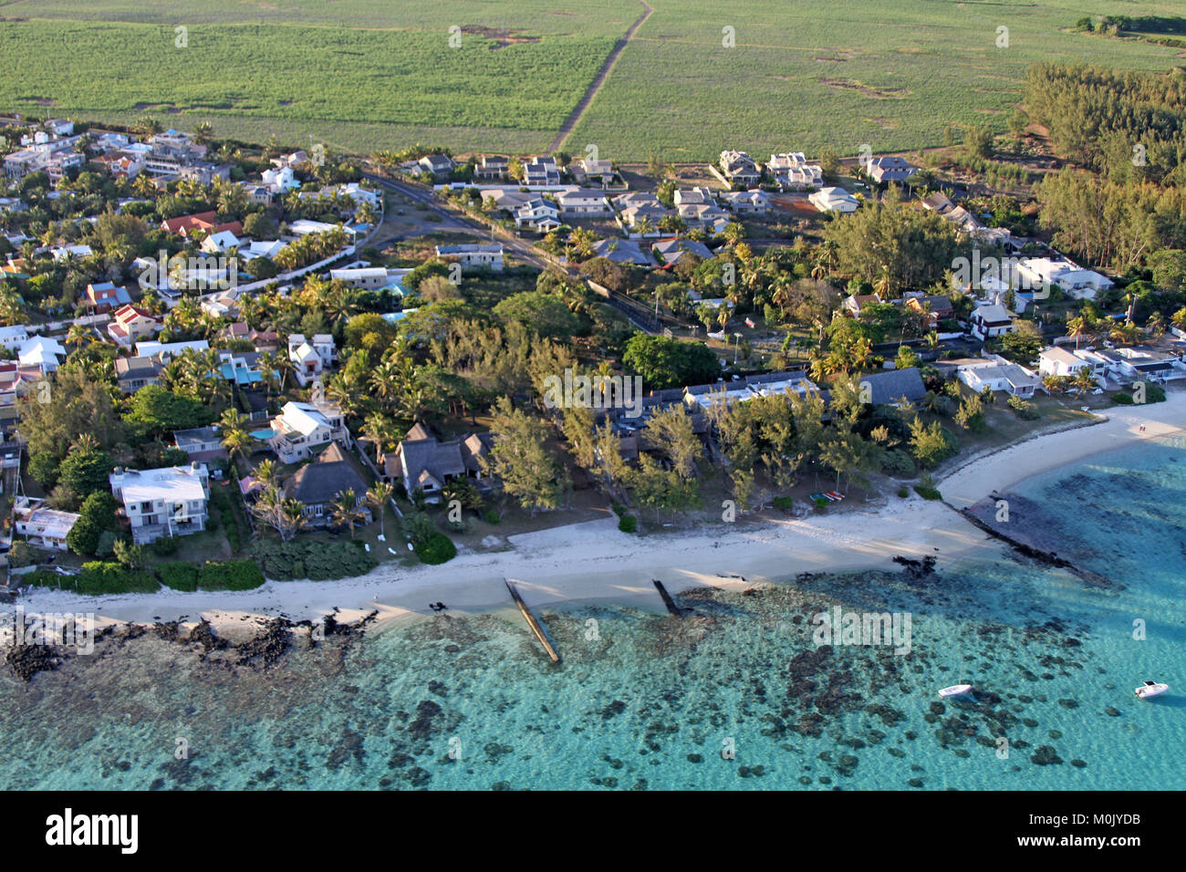 Lagoon, fields and farming village seen from a helicopter, Savanne ...