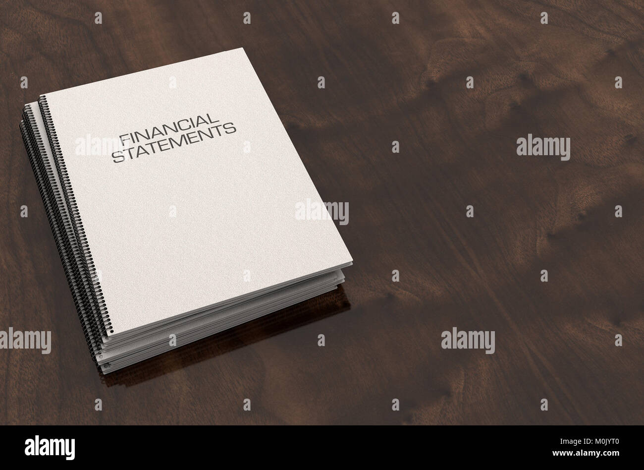 A pile of wire bound financial statement documents in a pile on a ...
