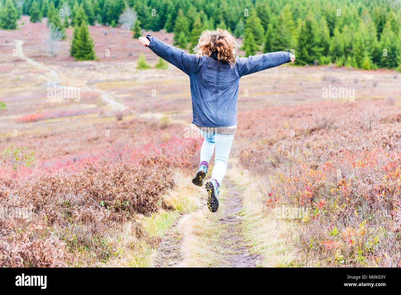 Young athletic, fit, free happy woman running jogging jumping in autumn ...