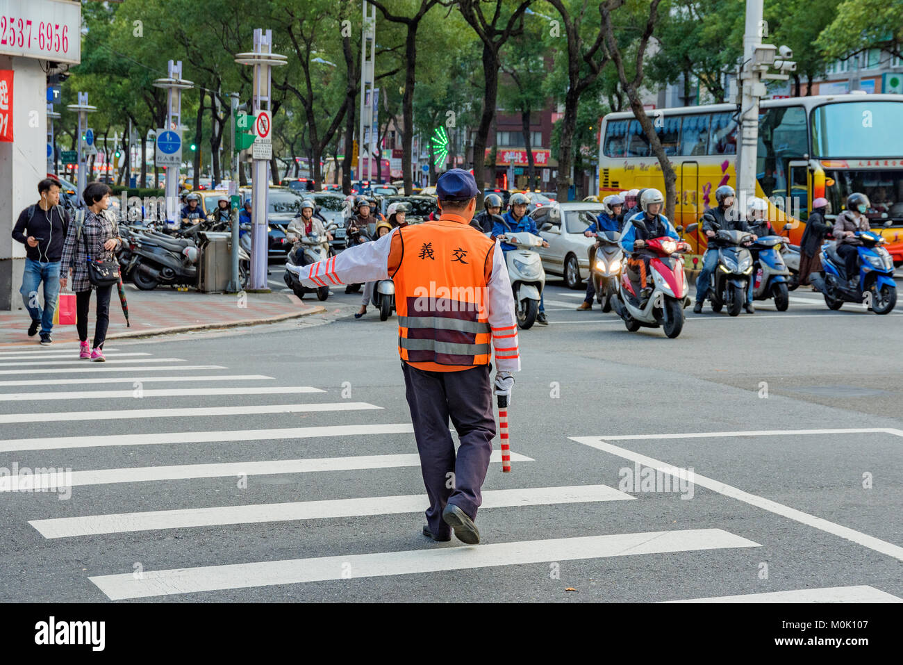 TAIPEI, TAIWAN - MARCH 24: Traffic officer on a pedestrian crossing in ...