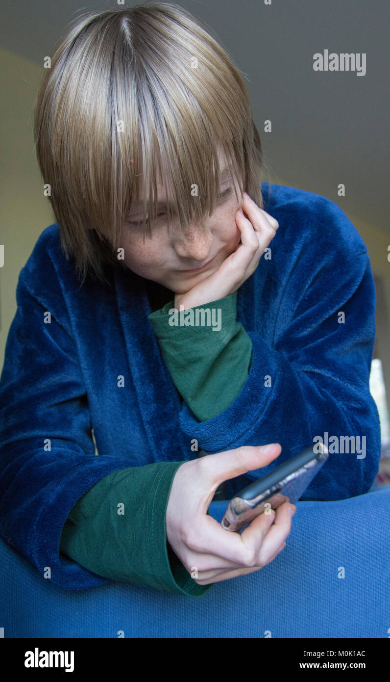 Young teenage boy using mobile phone Stock Photo - Alamy