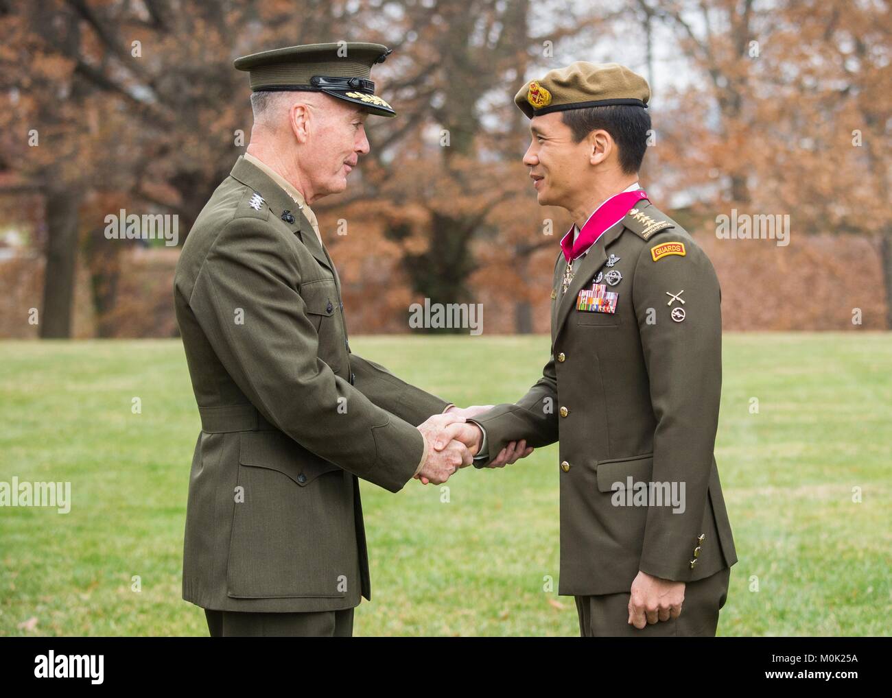 U.S. Joint Chiefs of Staff Chairman Joseph Dunford (left) presents ...