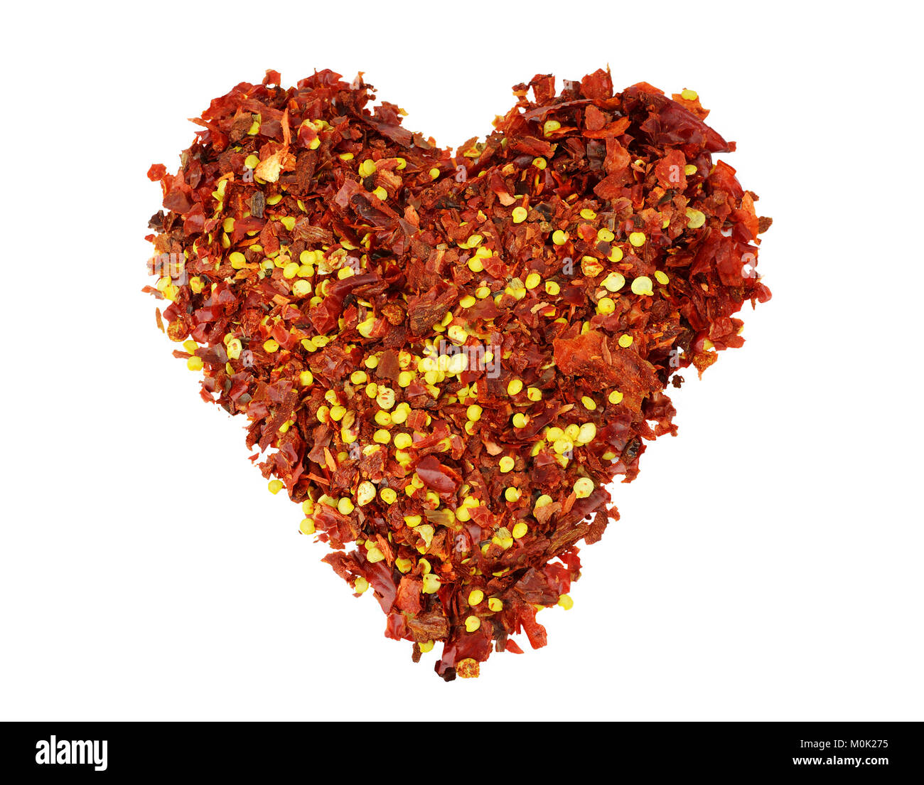 Crushed red chili pepper in heart shape isolated on a white background ...