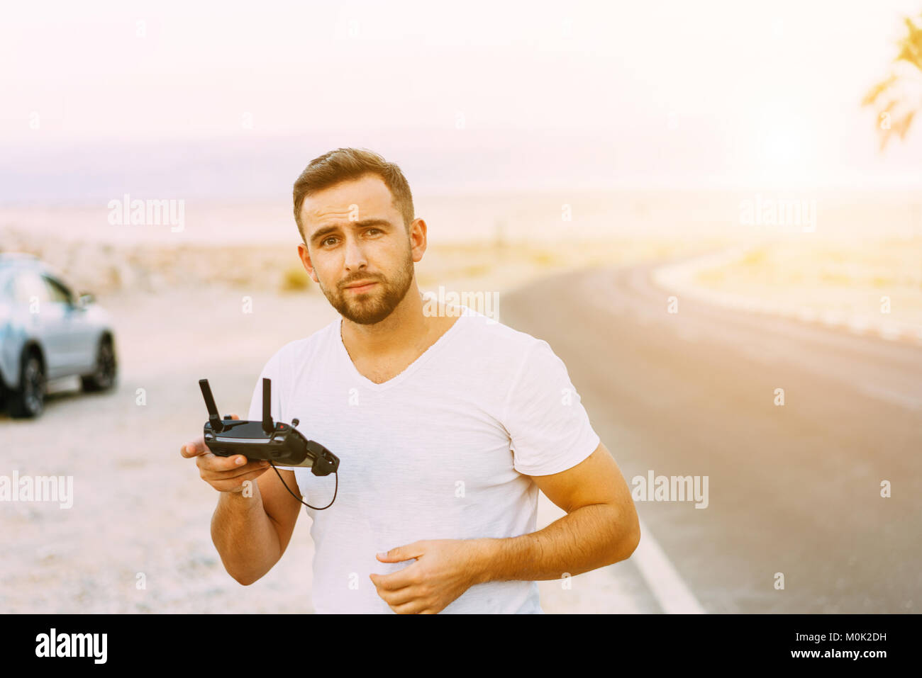 Guy controls drone with remote control Stock Photo - Alamy